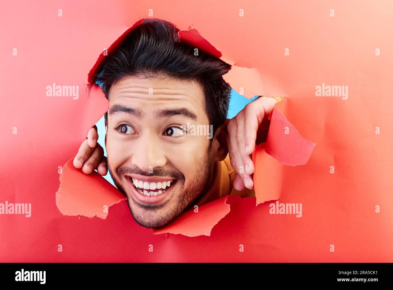 Man, studio and face breakthrough paper with smile, excited and ...