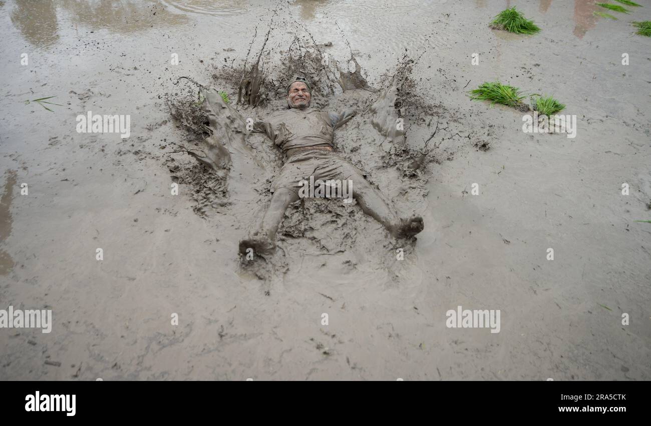 Kathmandu, Nepal. 30th June, 2023. People play in muddy water at a ...
