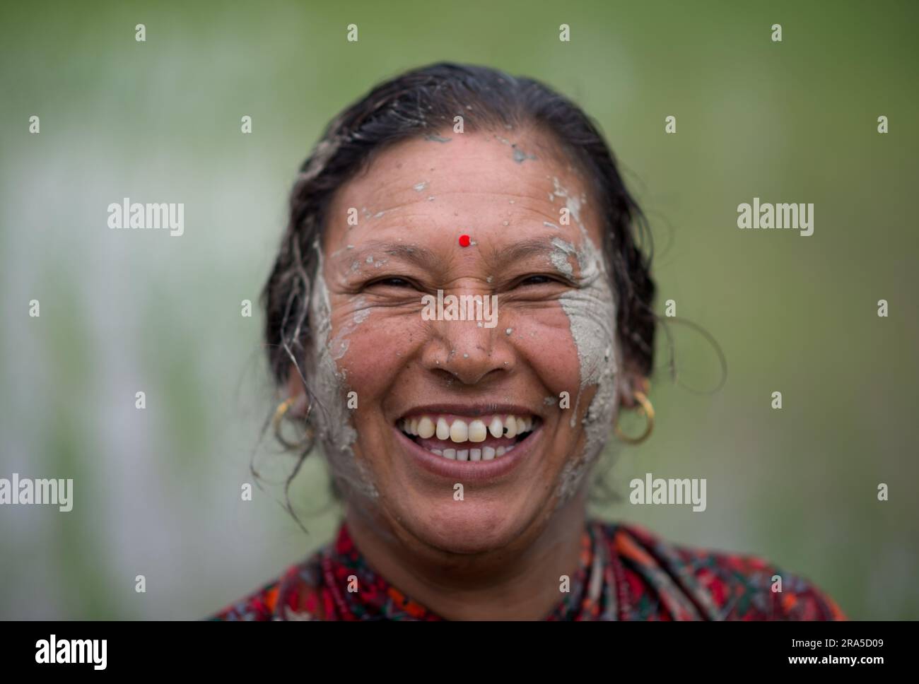 Kathmandu, Nepal. 30th June, 2023. A woman covered in mud smiles at a ...