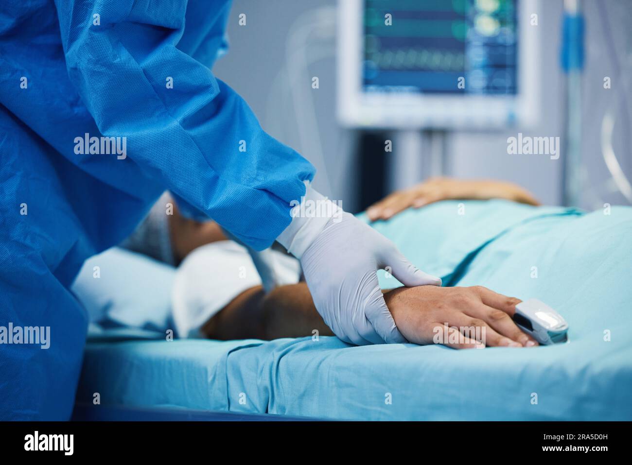 Holding hands, healthcare and a doctor with a patient in surgery for ...
