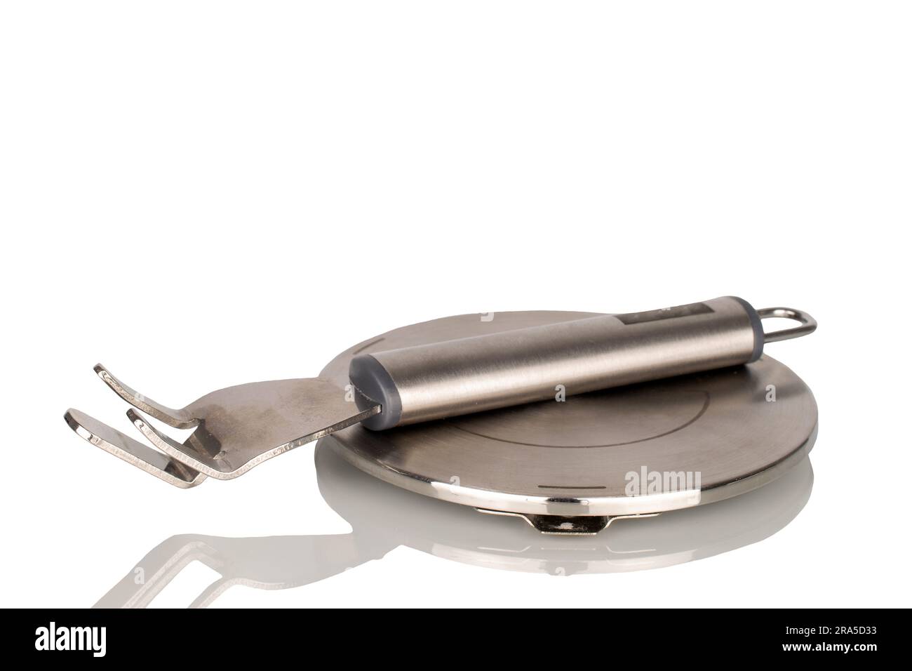 One metal adapter with handle for induction surface, macro, isolated on ...