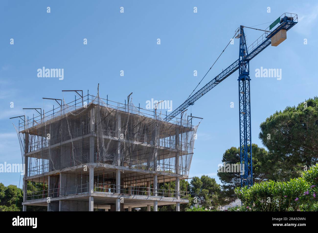 Residential building under construction with an industrial crane. Cala ...