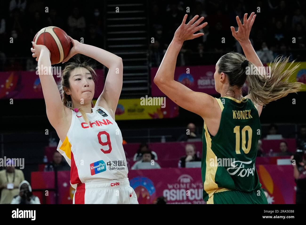 China's Li Meng looks to pass the ball past Australia's Alice Kunek ...