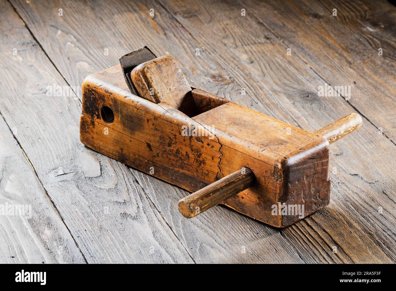 Old planer with signs of wear and age on a dark wooden background Stock ...