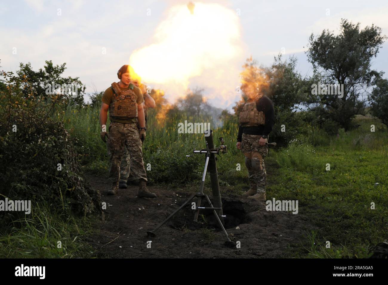 Ukrainian servicemen of the 3rd separate assault brigade fire a 82mm mortar towards Russian ...