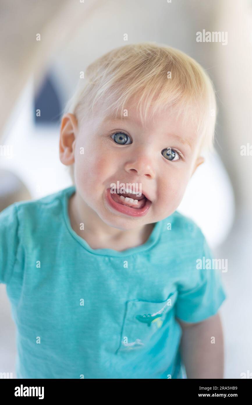 Portrait of cute little infant baby boy child playing on outdoor ...