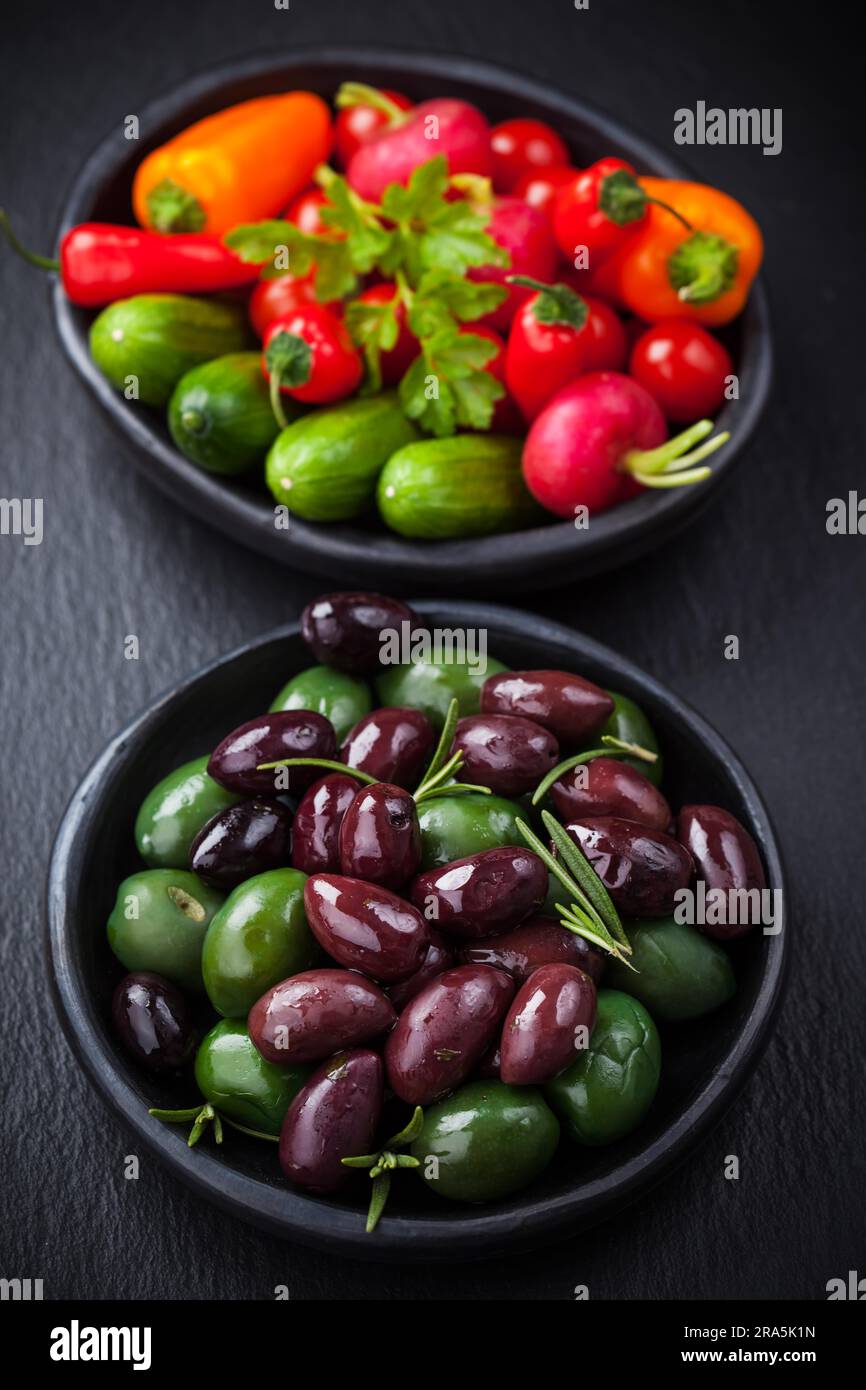 Mixed olives with raw snack vegetable as antipasti Stock Photo - Alamy