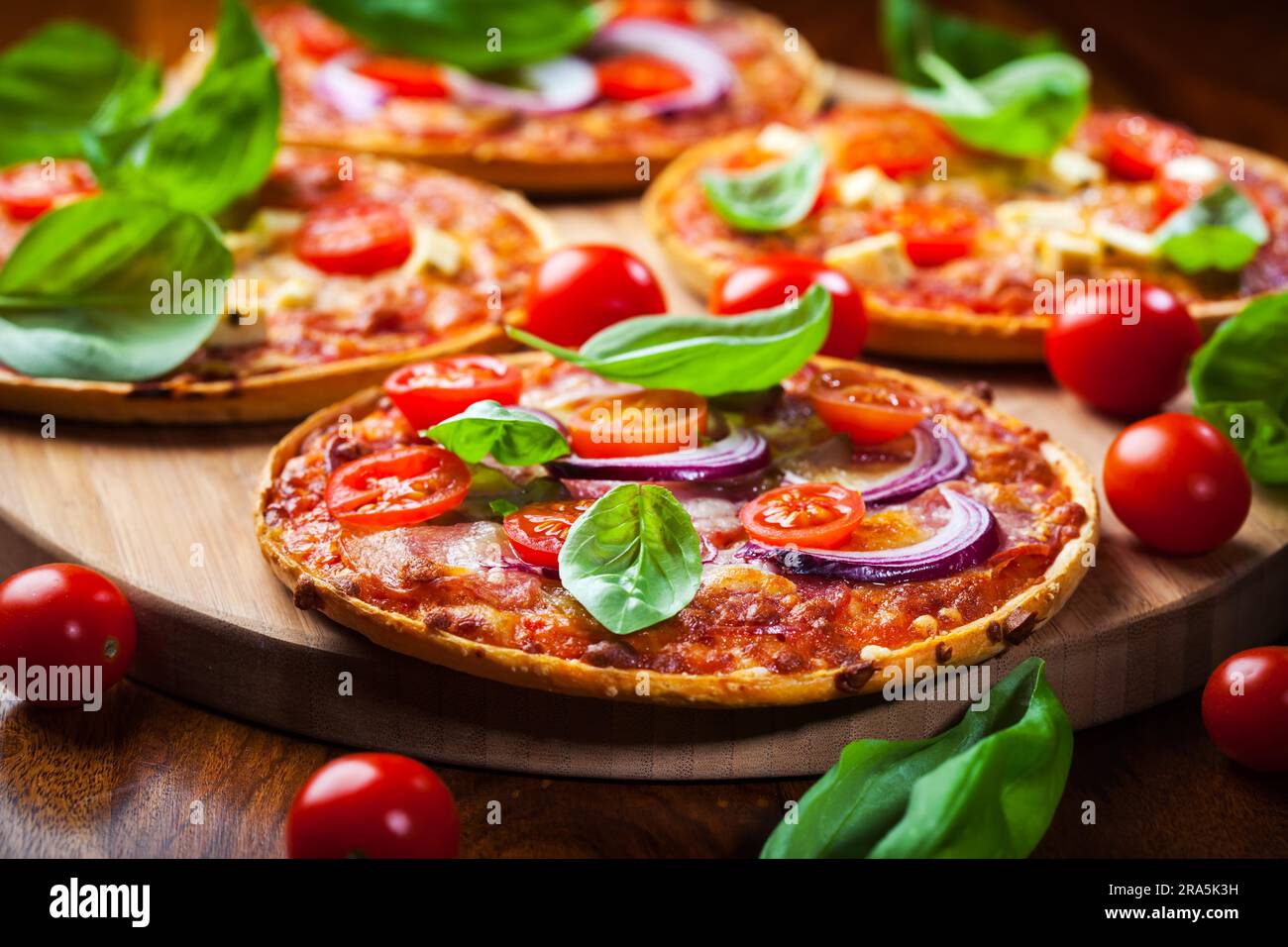 Homemade pizza with basil, tomatos and onion Stock Photo - Alamy