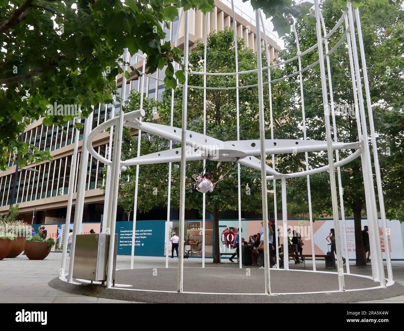 London, UK - June 2023 : A boy playing on the swing inside the giant 9 ...