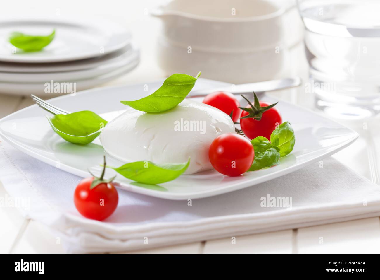 Fresh mozzarella with cherry tomatoes and basil Stock Photo - Alamy