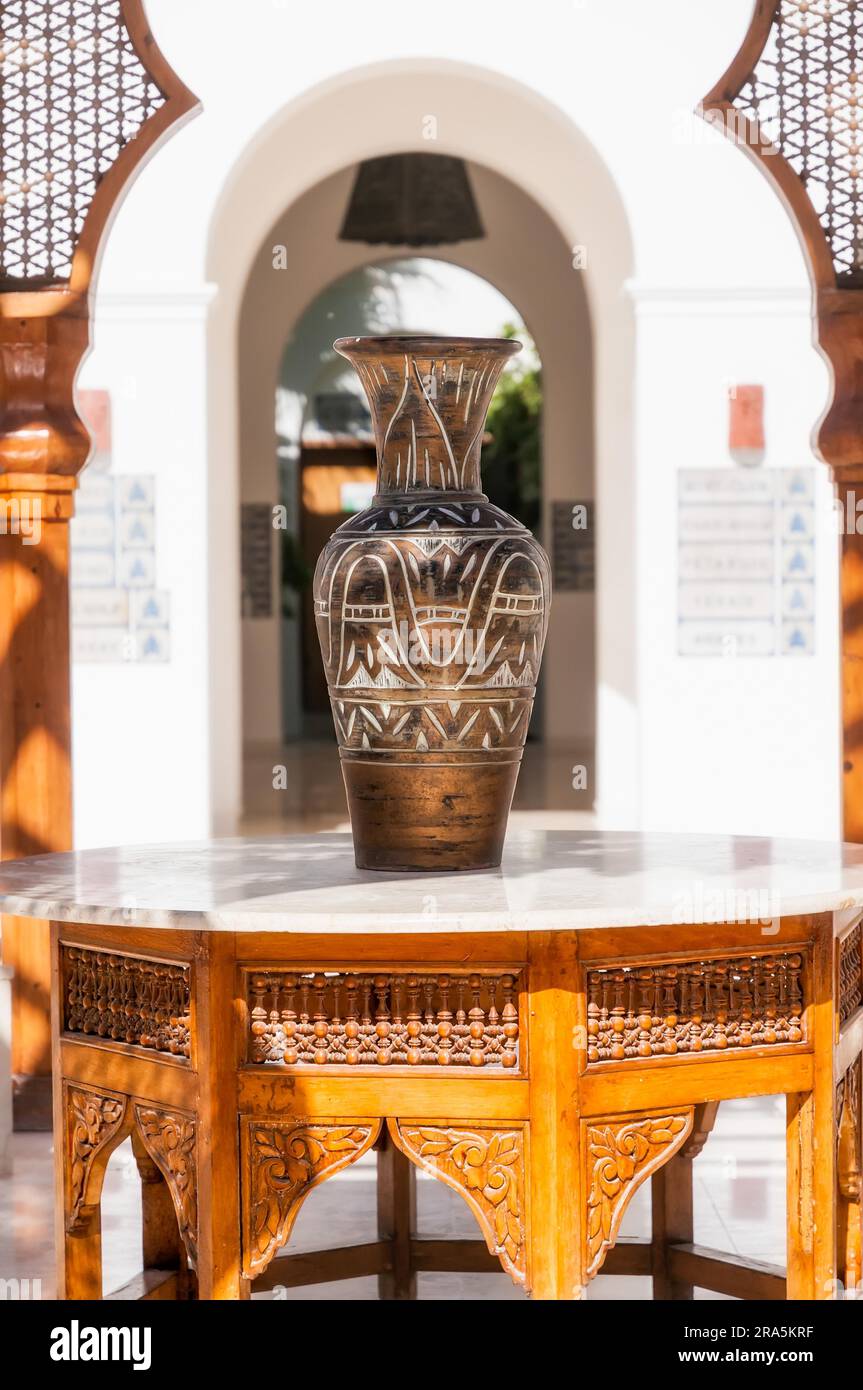 A big egyptian vase on a wood and marble arabian table Stock Photo - Alamy