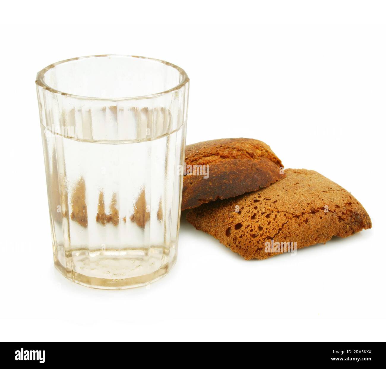 Crust of bread and glass of alcohol isolated on a white background ...
