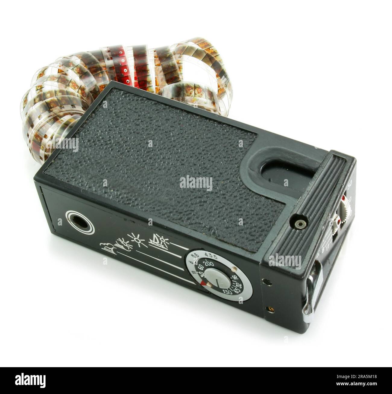 Small espionage photo camera and film isolated on a white background ...