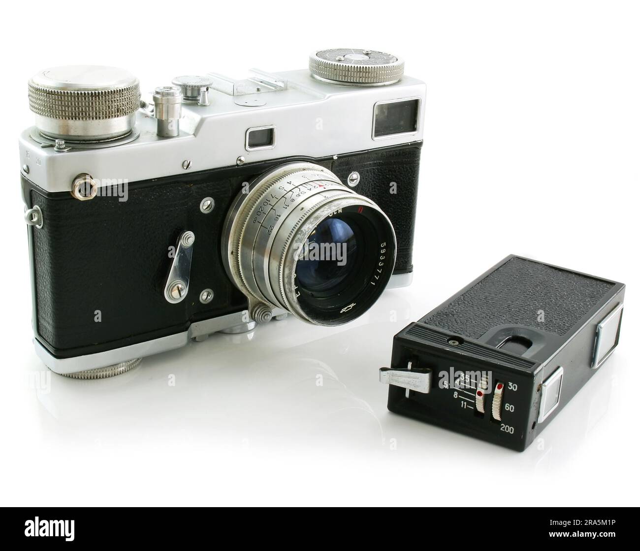 Small espionage photo camera and film camera isolated on a white ...