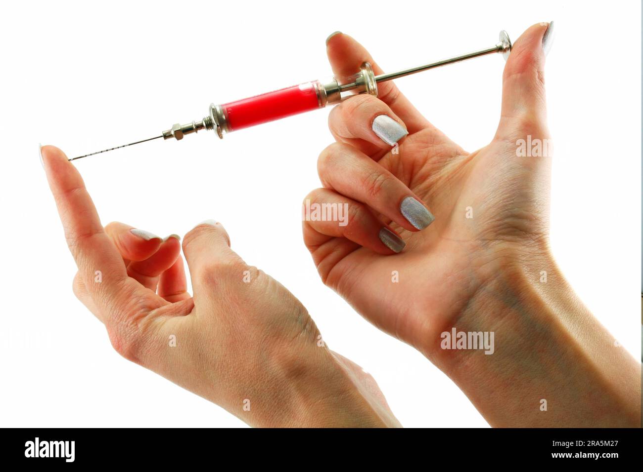 Reusable syringe full of acid substance in hands isolated on a white ...