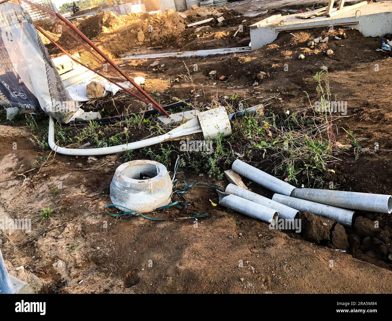 there are concrete structures, spare parts, pipes, metal circles at the ...