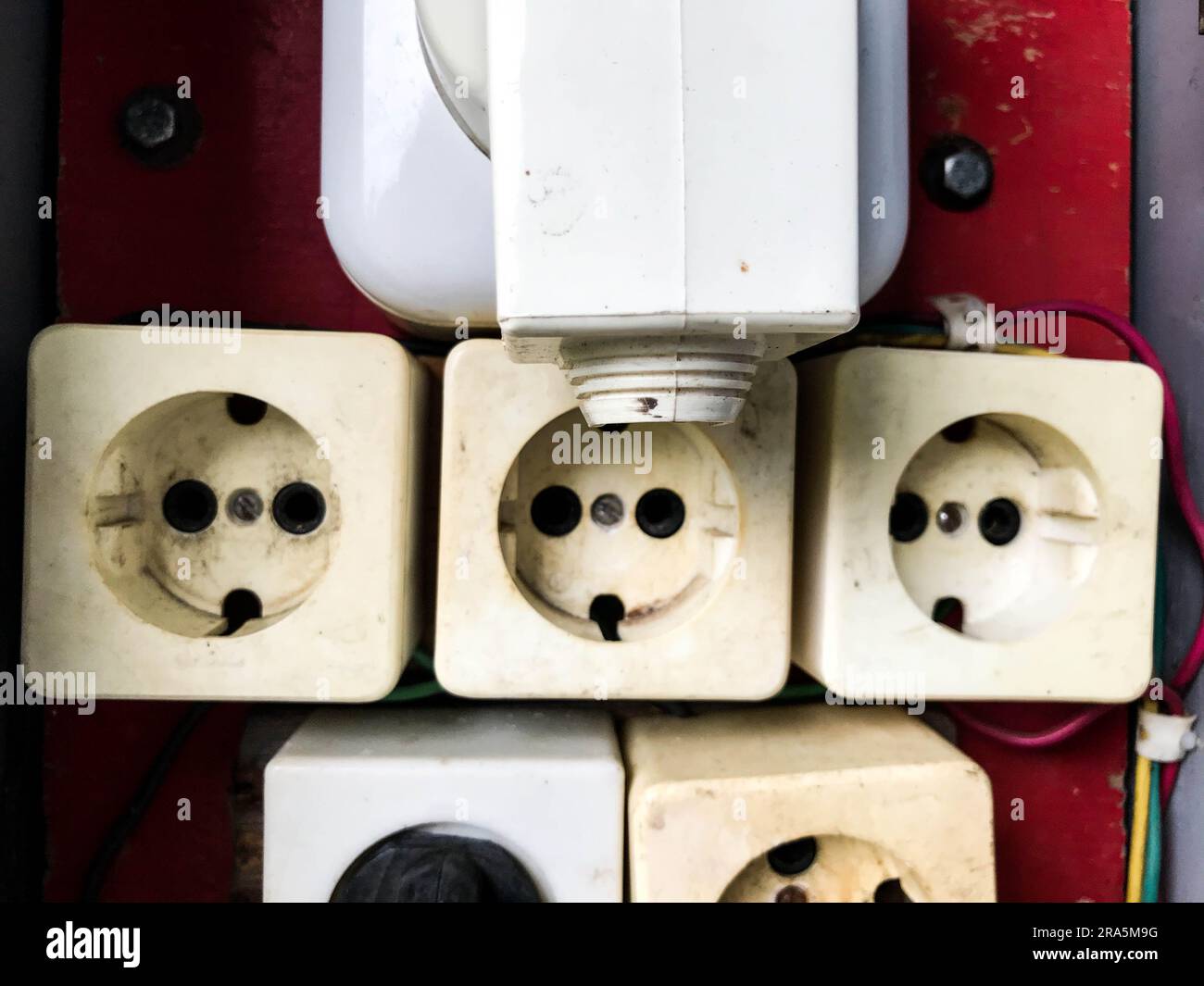 texture with white rosettes. electrical panel with several white ...