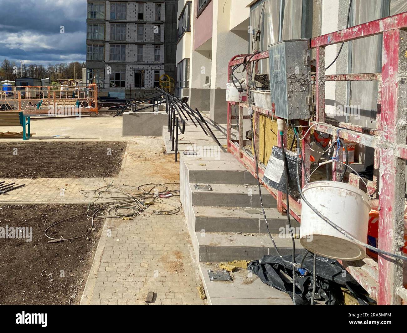 Builder on suspended construction cradle paint the shasad of a new ...