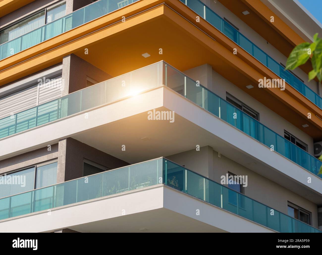 New apartment building with large balconies with glass railings. Modern ...