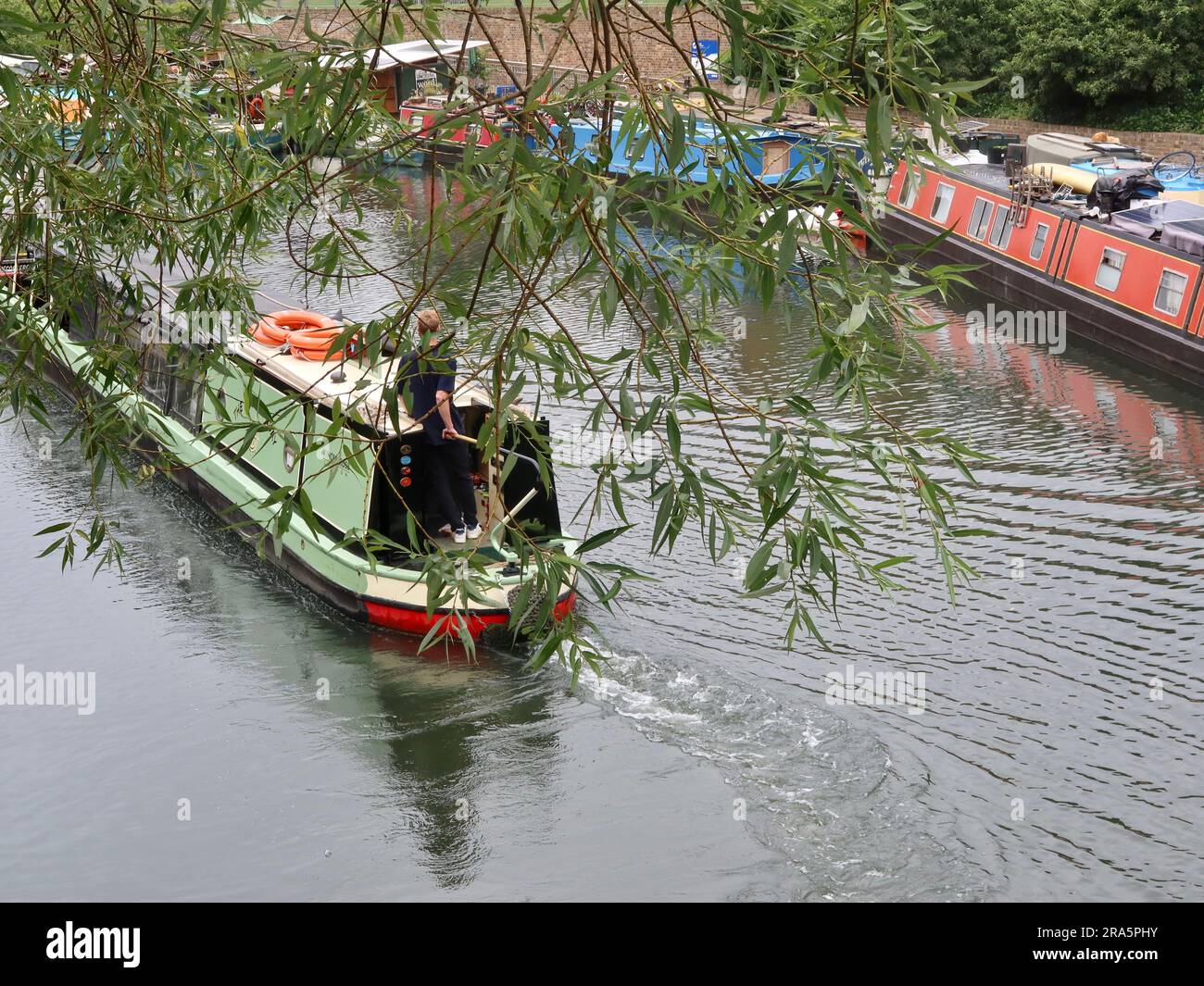 London, UK - June 2023 : Barges and canal boats on the Regents Canal ...