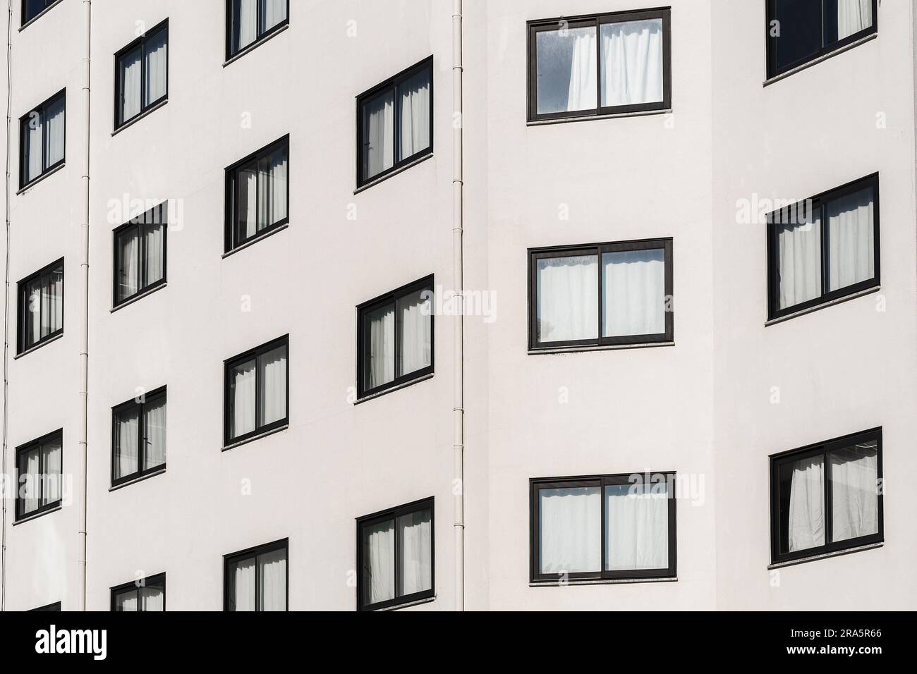 Tall multi-storey building with identical windows. Background building ...
