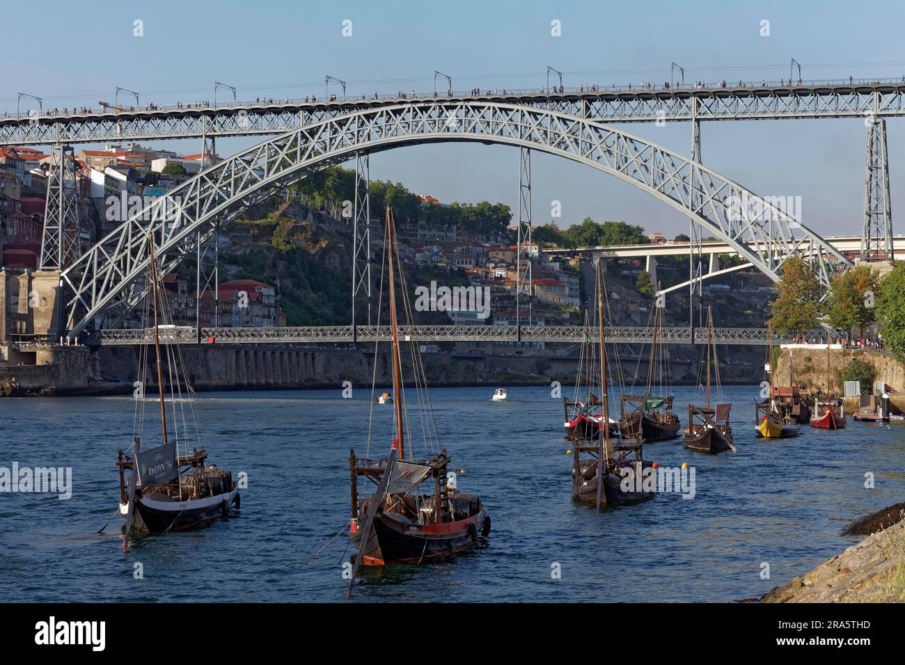 Historic barges with port wine barrels on the Douro River, Ponte D ...