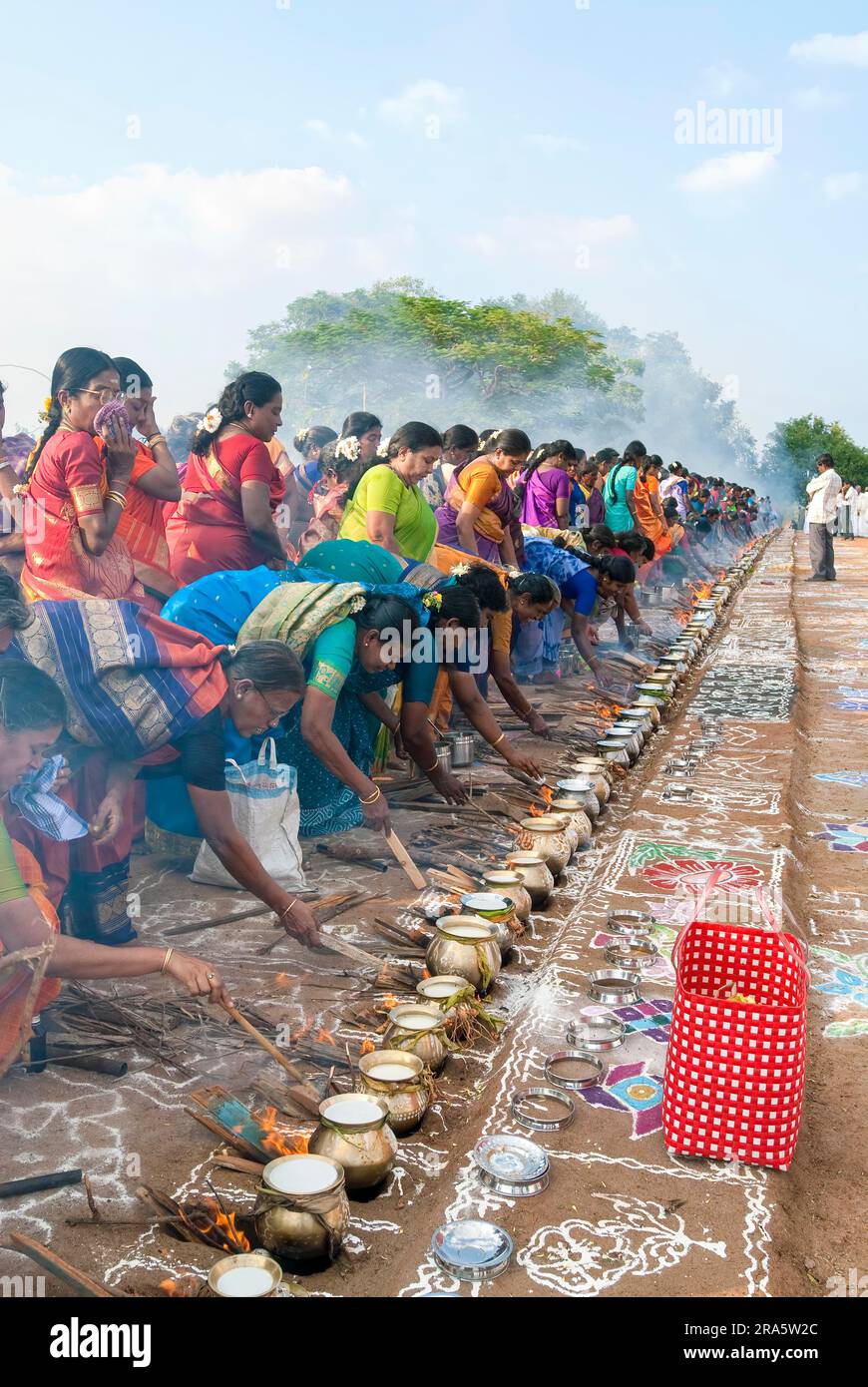 Women celebrating Sevvai Tuesday Pongal festival on firewood stove ...
