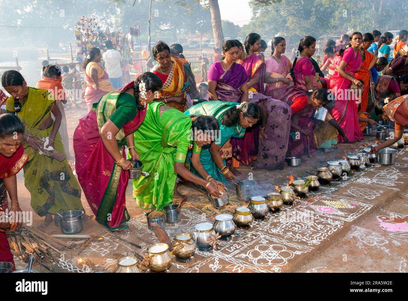 Women celebrating Sevvai Tuesday Pongal festival on firewood stove ...