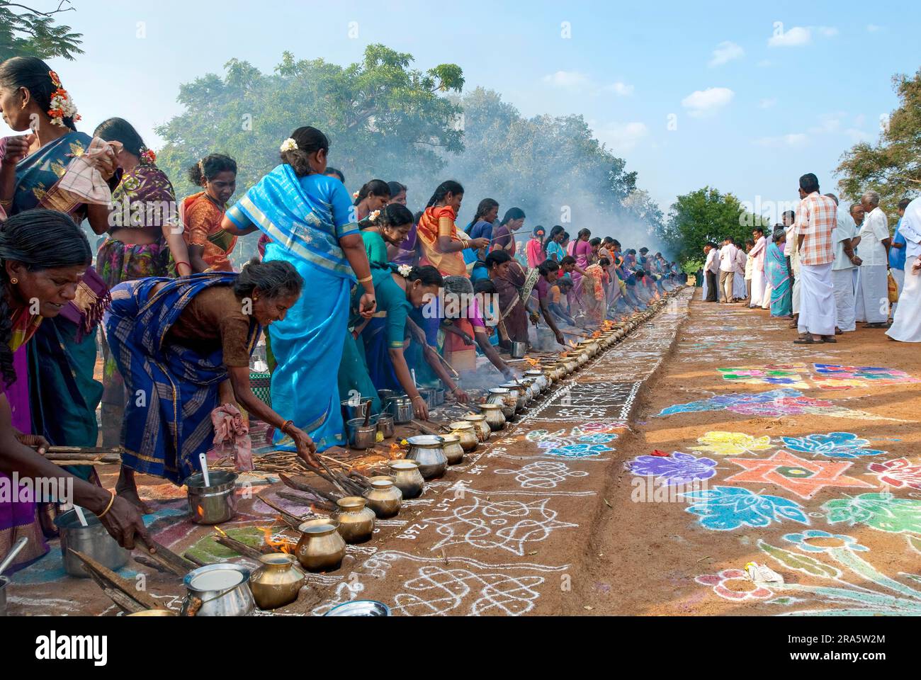 Women celebrating Sevvai Tuesday Pongal festival on firewood stove ...