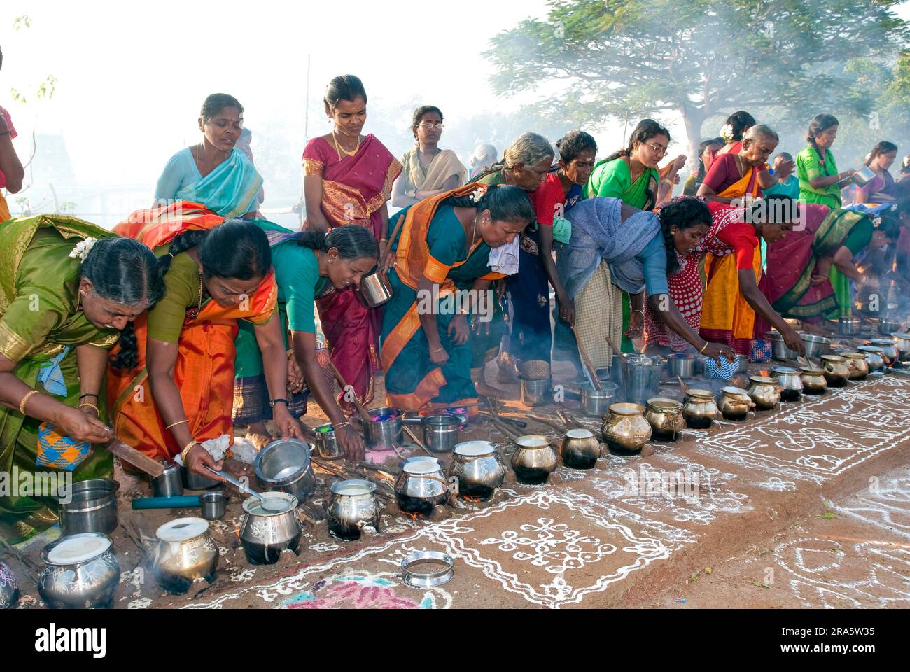 Women celebrating Sevvai Tuesday Pongal festival on firewood stove ...