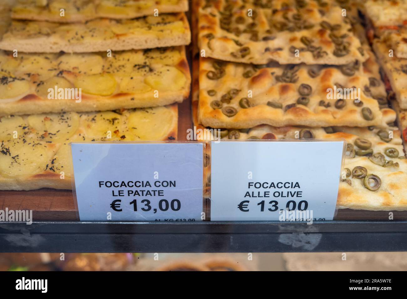Freshly baked focaccia bread in a shop window in Genoa with the price ...