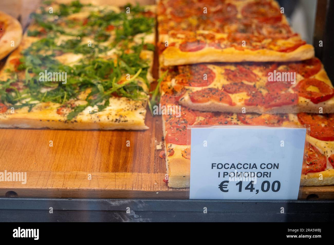 Freshly baked focaccia bread in a shop window in Genoa with the price ...
