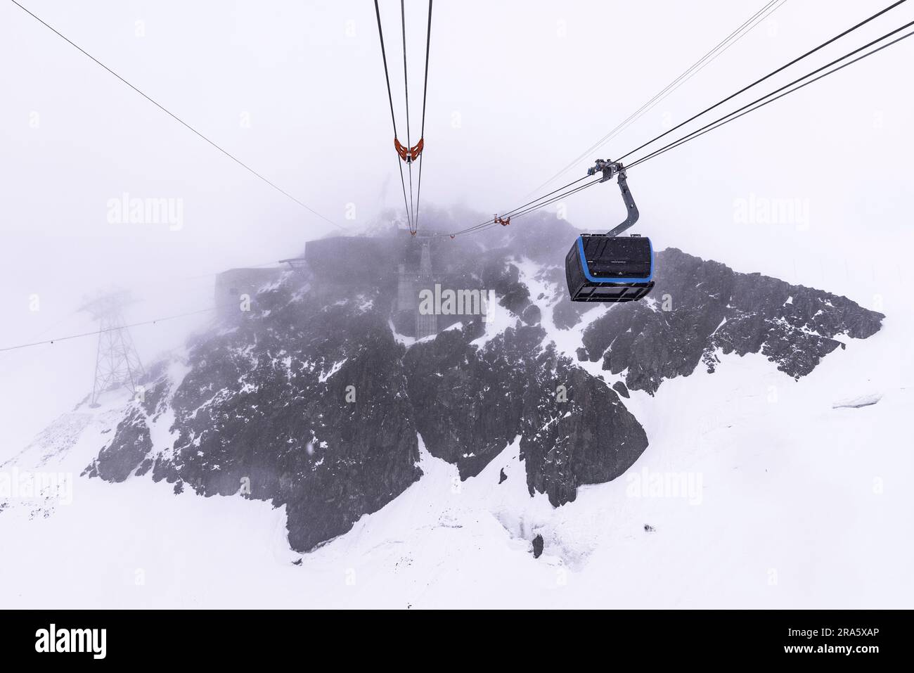 A view out of a the new gondola towards mountain station Klein ...