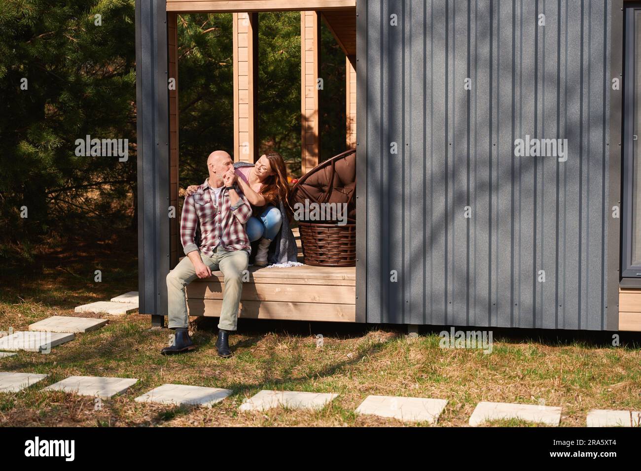 Romantic couple enjoying each other company on cottage veranda Stock ...