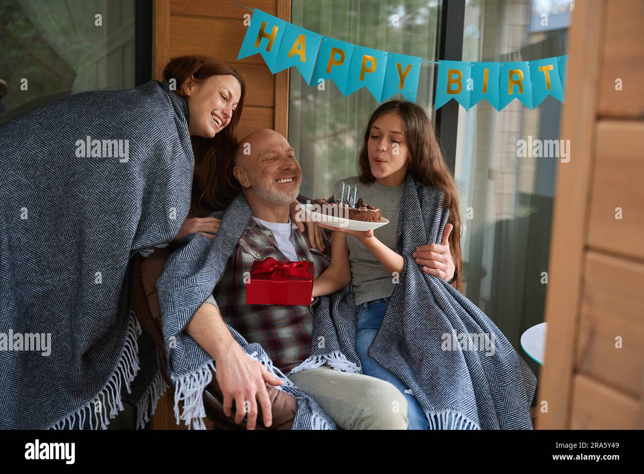 Daughter and female spouse congratulating birthday person on cottage ...