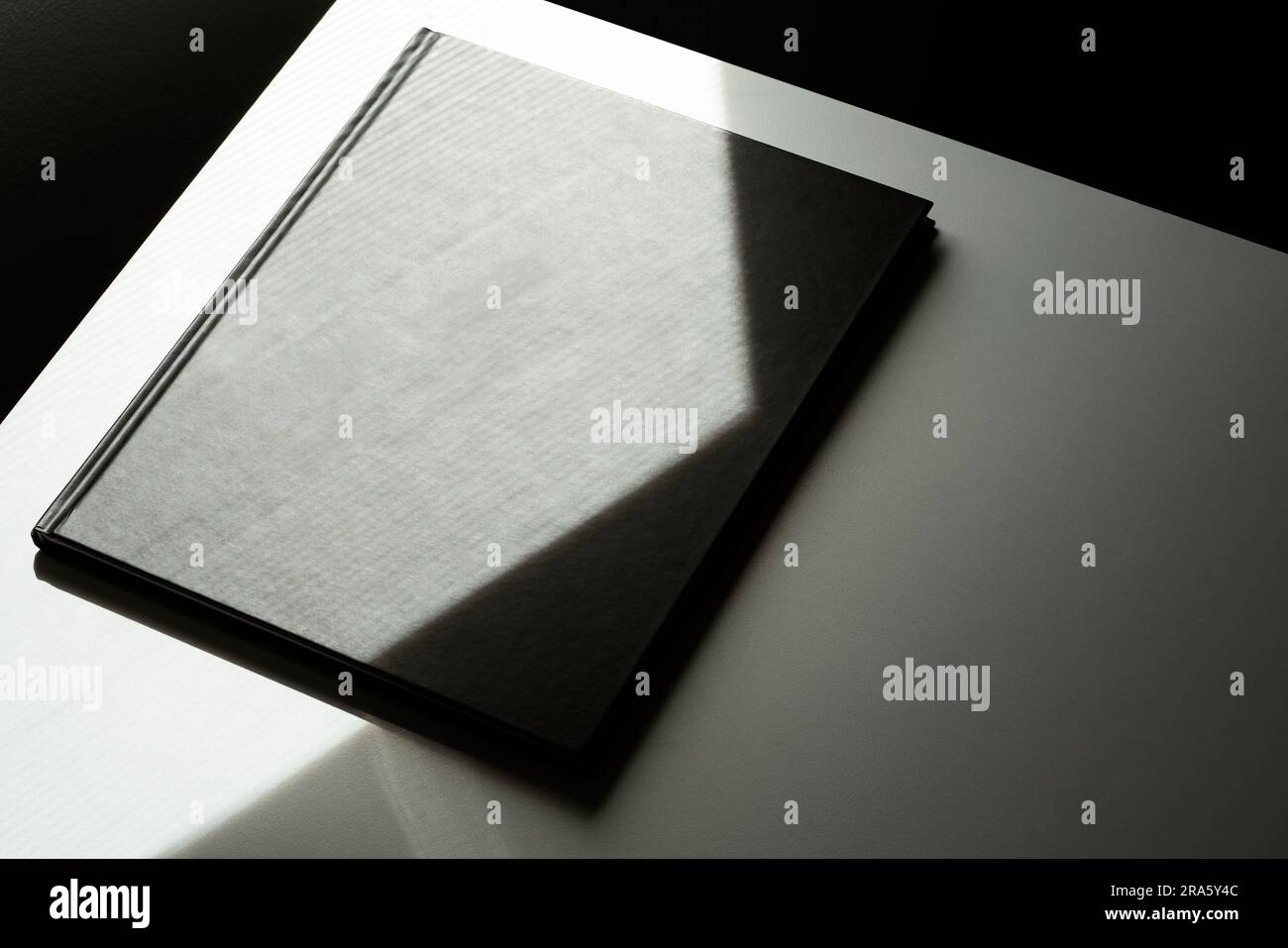 Black blank magazine cover mockup, template at the corner of the table ...