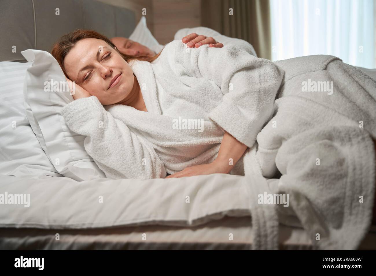 Married couple dozing off in bedroom in morning Stock Photo - Alamy