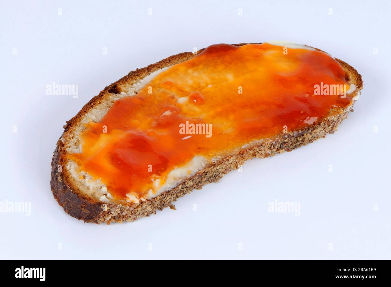 Rosehip jam as spread (pink), slice of bread Stock Photo - Alamy