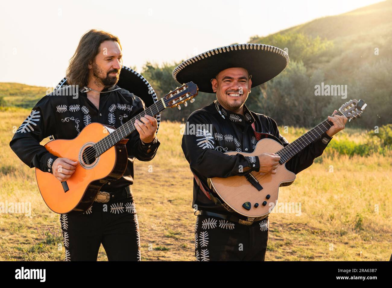 Mexican musicians mariachi play guitars Stock Photo - Alamy