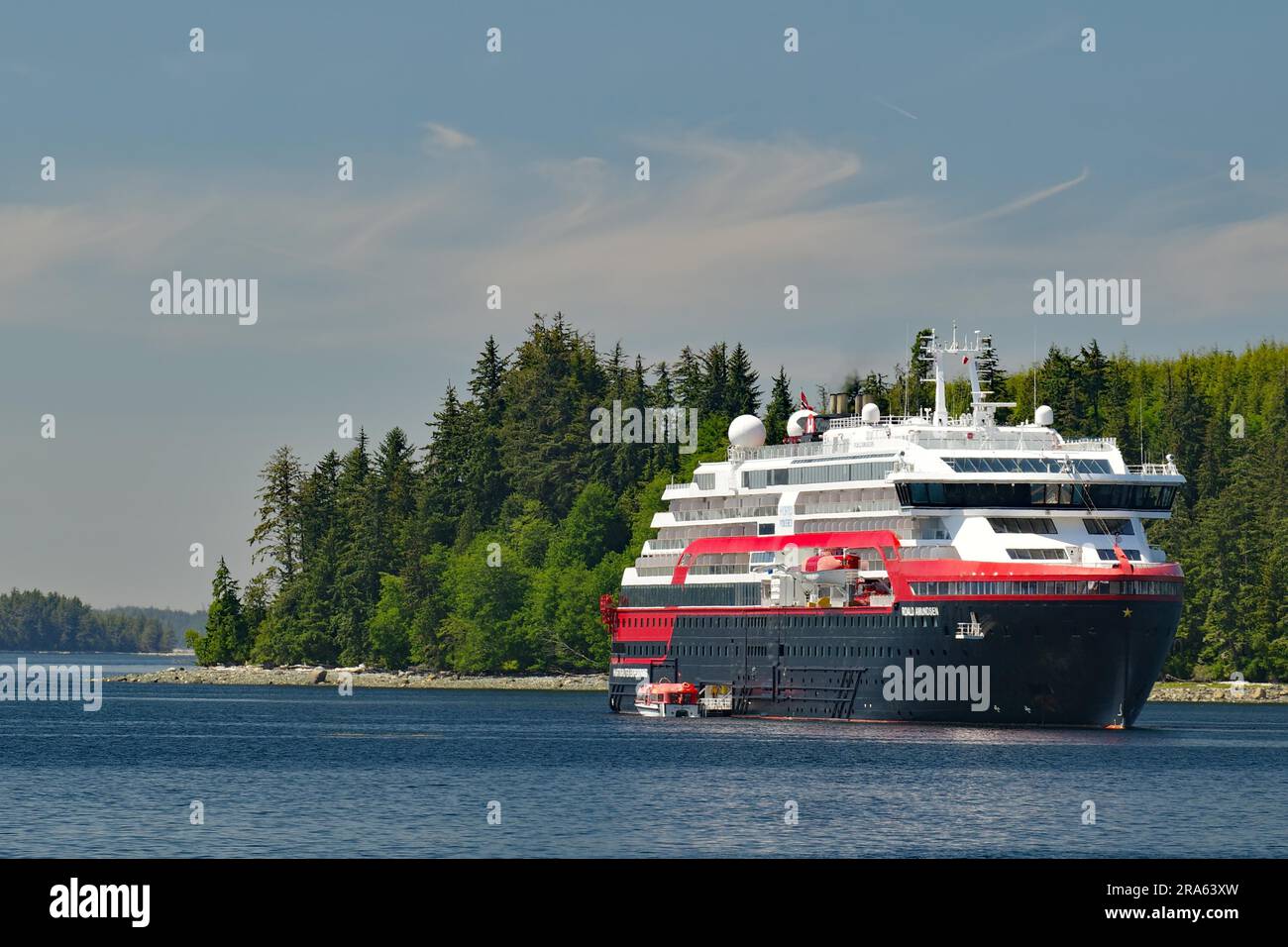 A Hurtigruten expedition ship lies in a small bay, Alert Bay, Vancouver ...