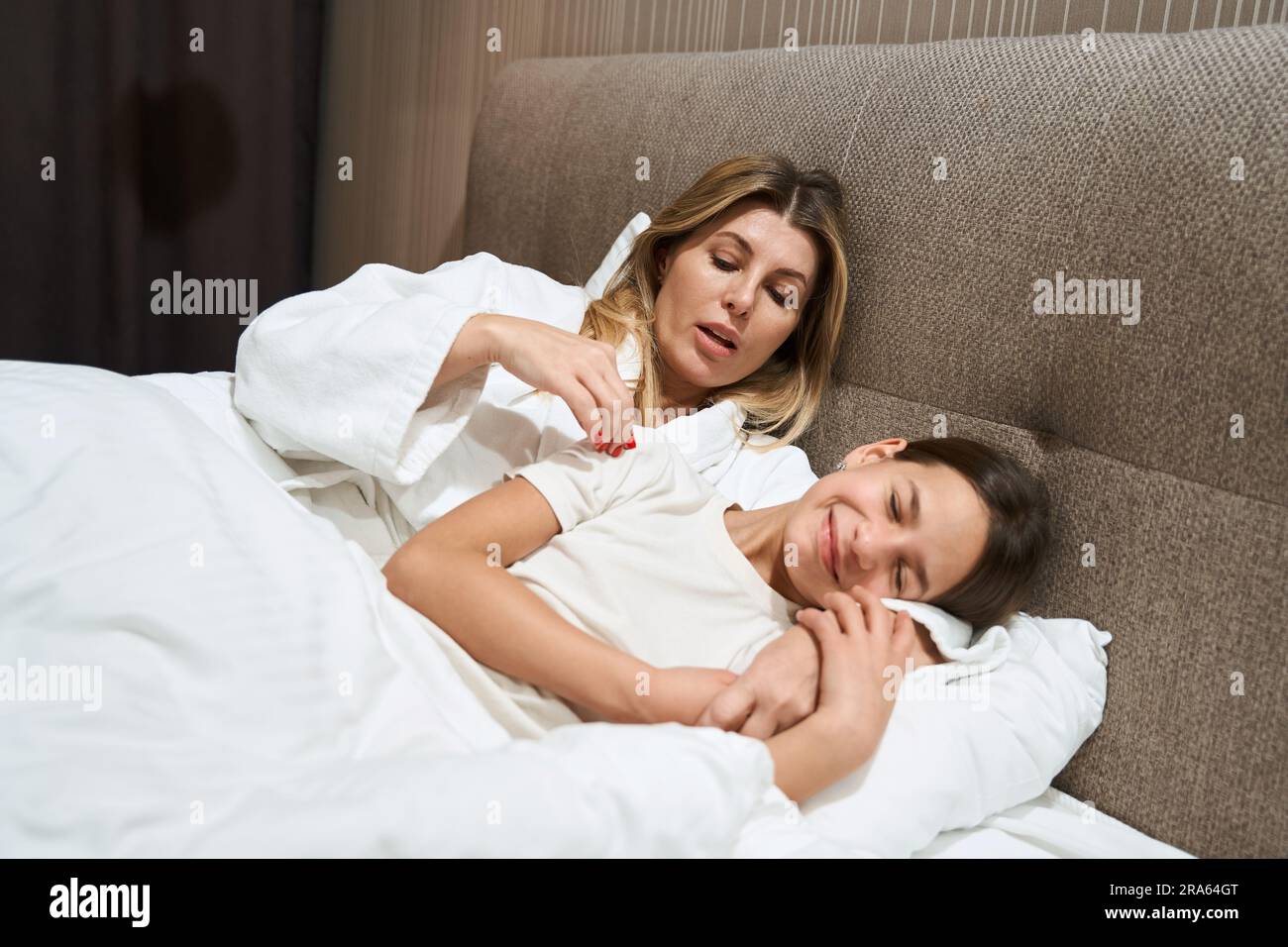 Mother and girl resting in the bedroom Stock Photo - Alamy