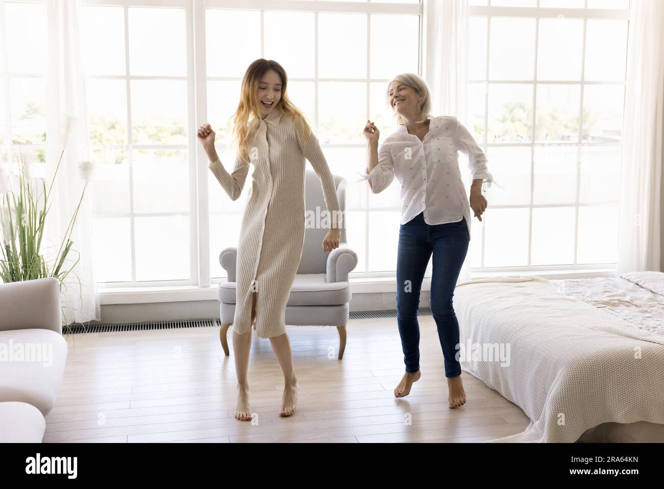 Joyful grandma and teenage kid dancing at home together Stock Photo - Alamy