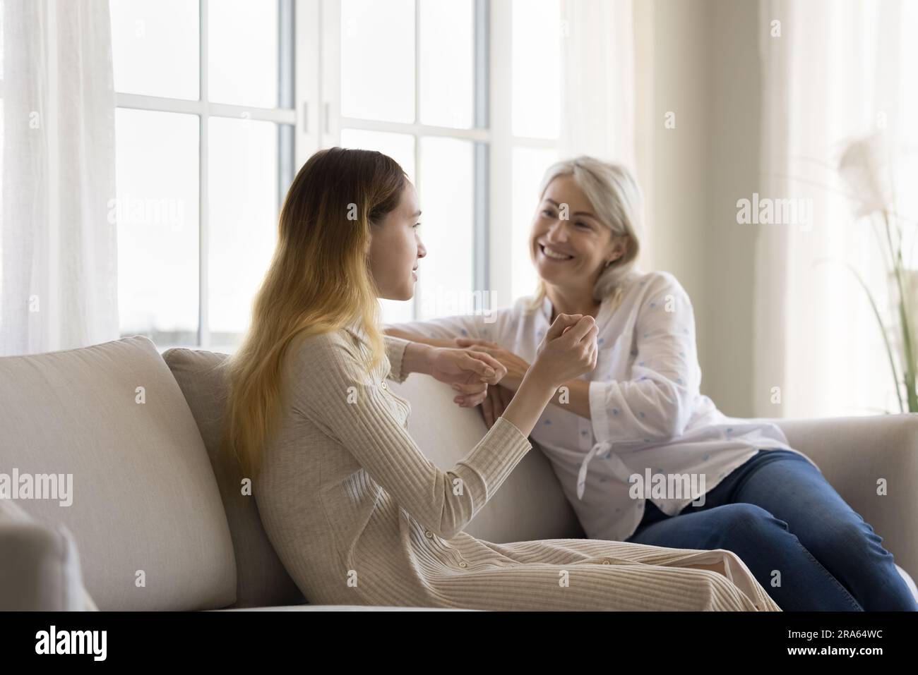 Preteen talking to an adult sofa hi-res stock photography and images ...