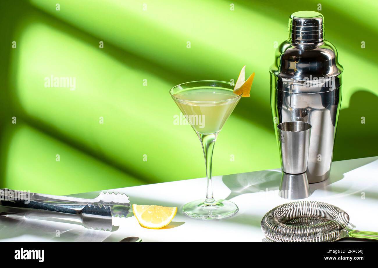 Vesper cocktail drink with dry gin, vodka, aperitif, lemon zest and ice ...