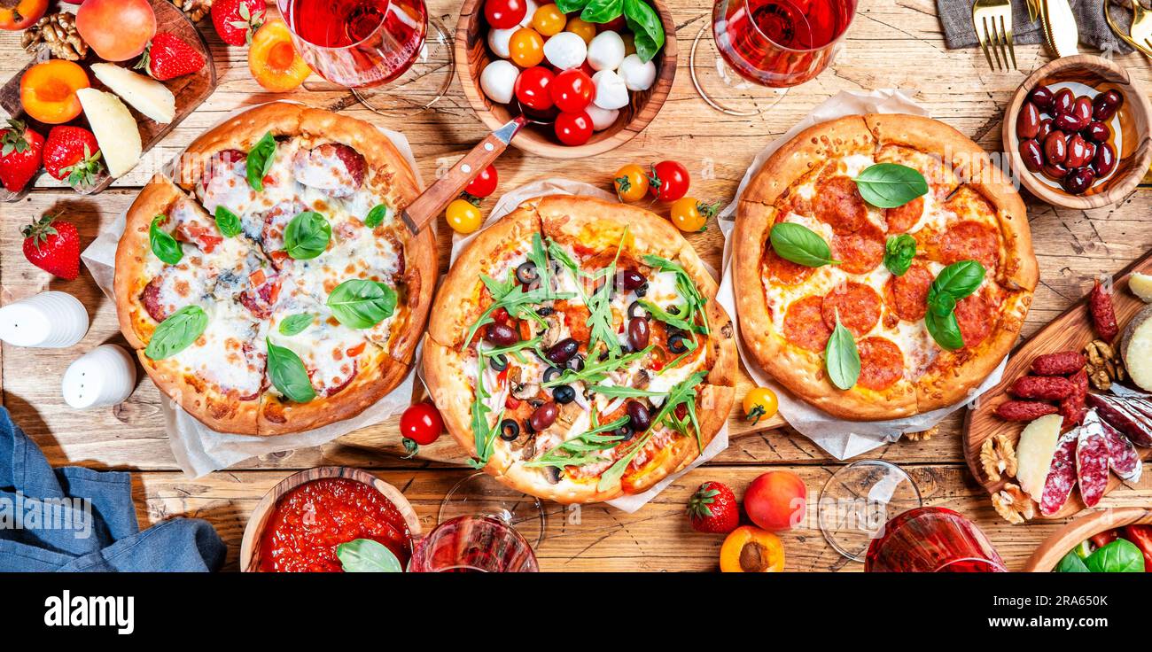 Pizza party table. Top view glasses with red wine, rustic wooden table ...