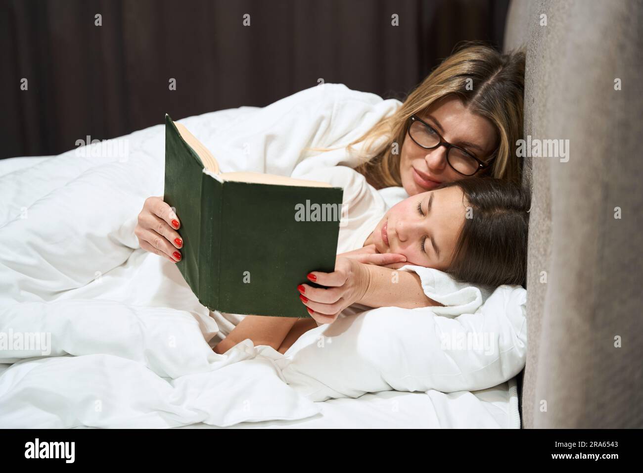 Woman reading fairy tale before going to bed Stock Photo - Alamy
