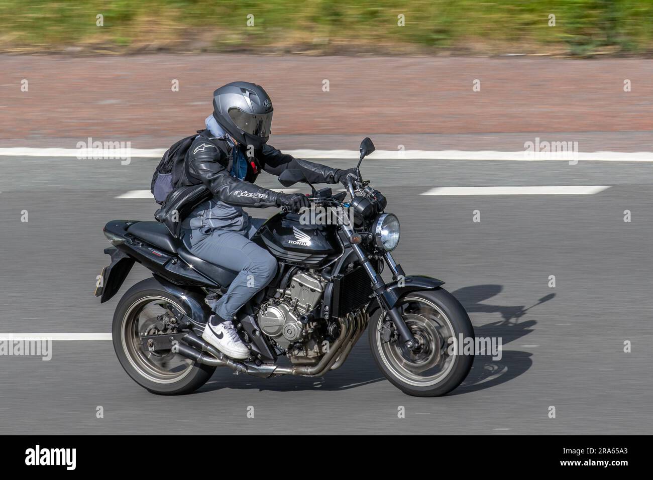 Honda cruiser motorcycle rider with visor down travelling at speed on ...