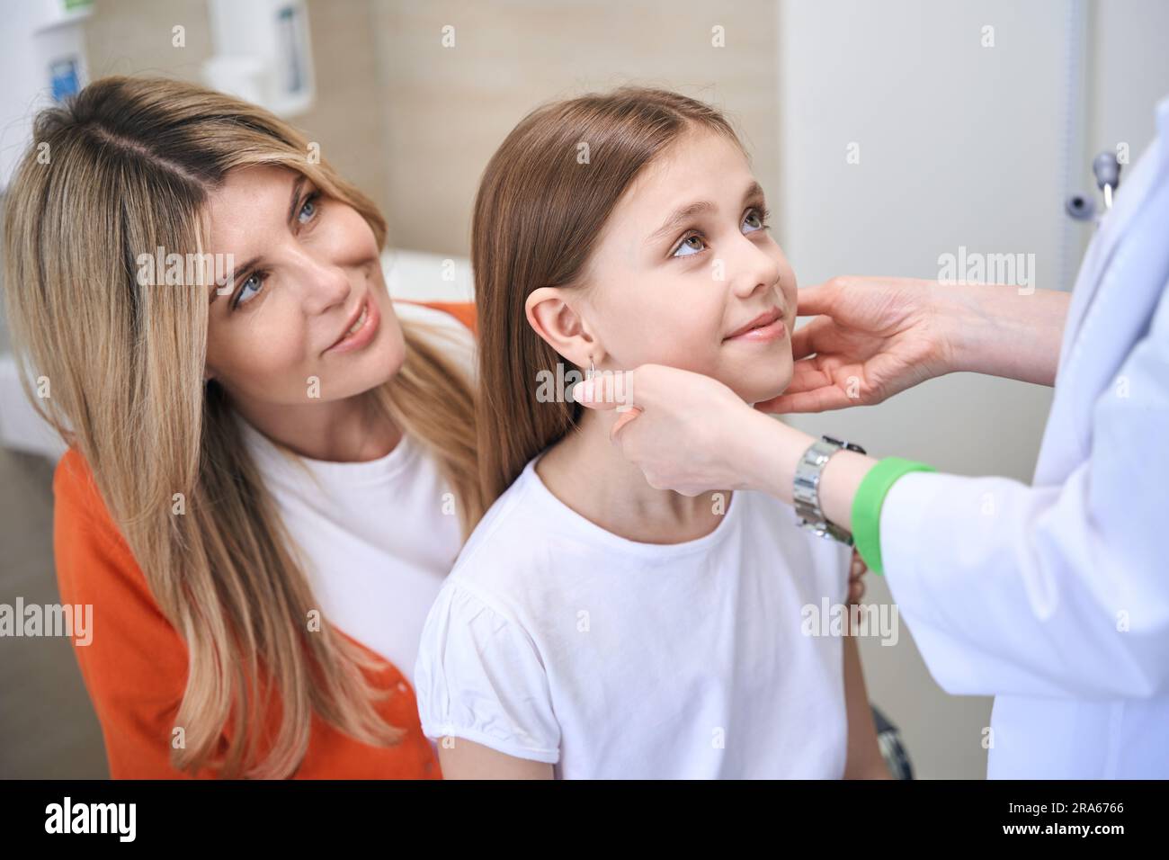 Caring laryngologist examining llittle girl lymph nodes Stock Photo - Alamy