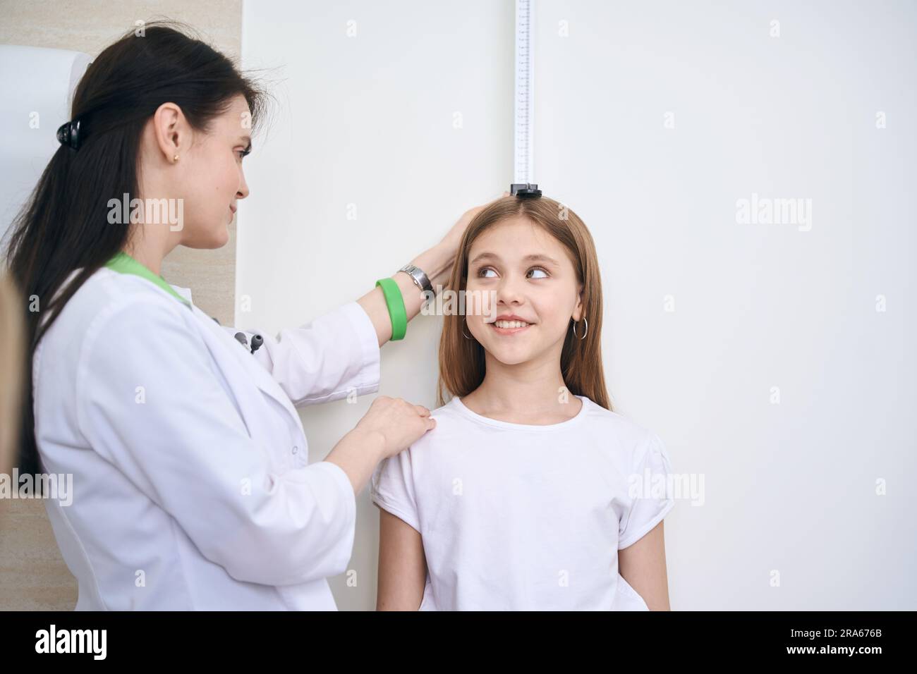 Pediatrician measuring little girl height with special tool Stock Photo ...