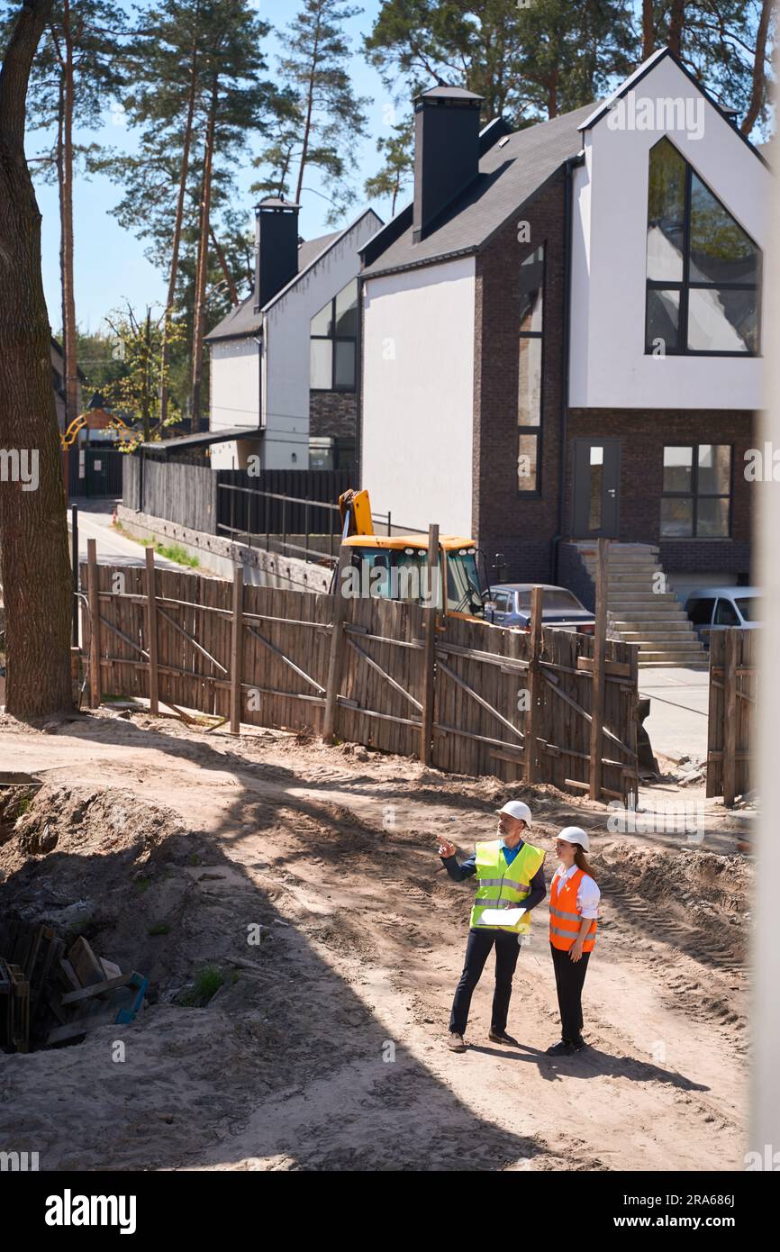Landscape designer inspecting construction site, planning future garden ...